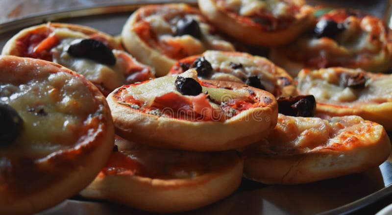 Stack of Mini Pizzas with One Black Olive on the Top of Each One Stock ...