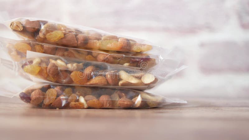 Stack of Mixed Nuts in a Plastic Packet on Table Stock Video - Video of ...