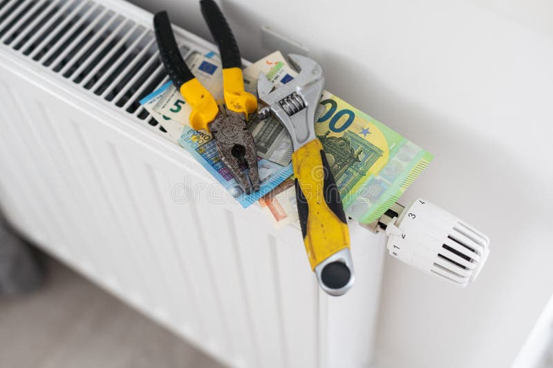 A Stack of Money on the Background of the Radiator. Expensive Utilities ...