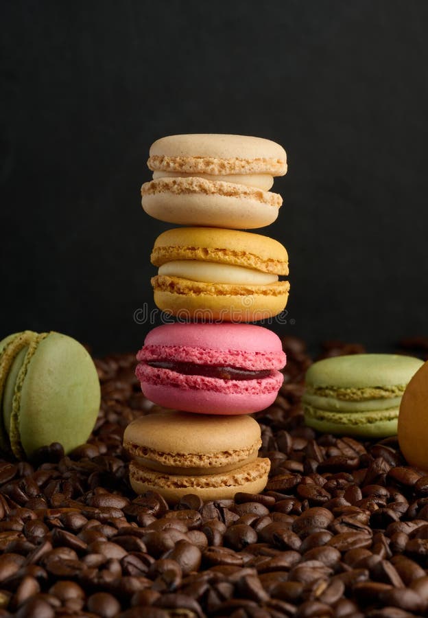 Stack of Multi-colored Macarons on a Background of Coffee Beans, Black ...
