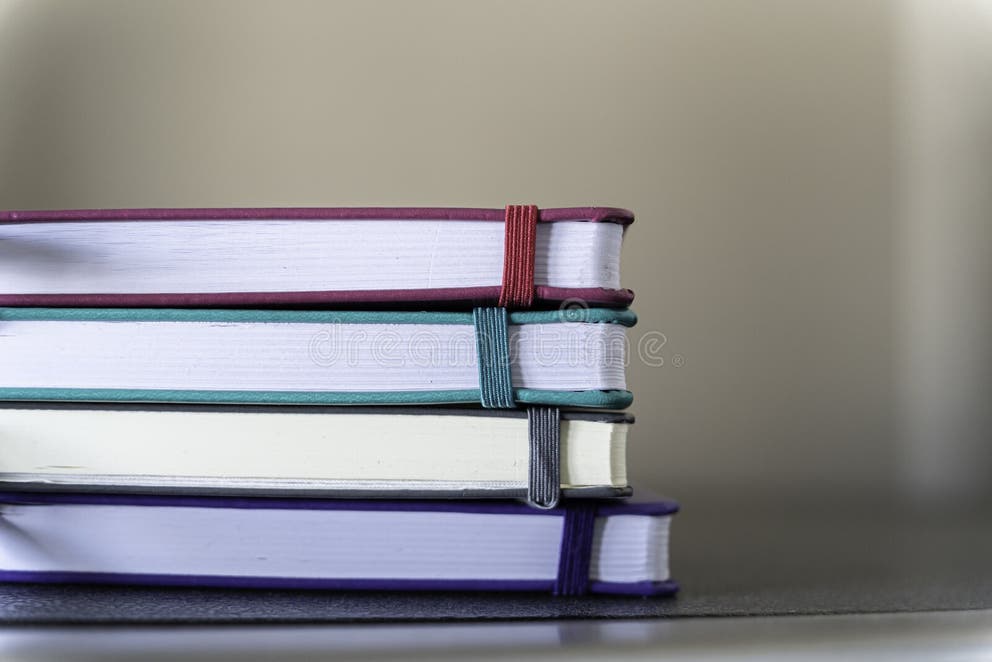 Stack of Multi Colored Notebooks and Pencil on Office Table Stock Photo ...