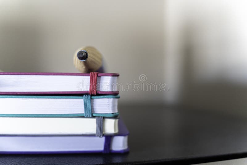 Stack of Multi Colored Notebooks and Pencil on Office Table Stock Image ...