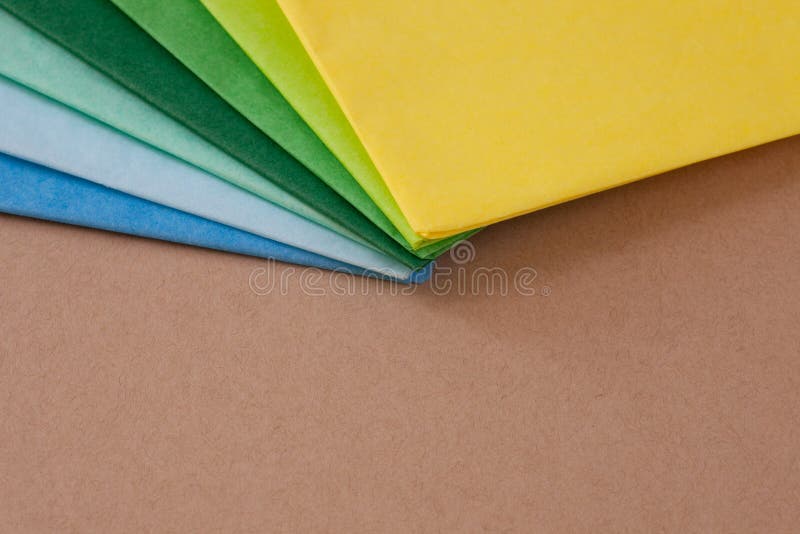 A Stack of Multi Colored Tissue Paper Spread Out in a Fan on a ...
