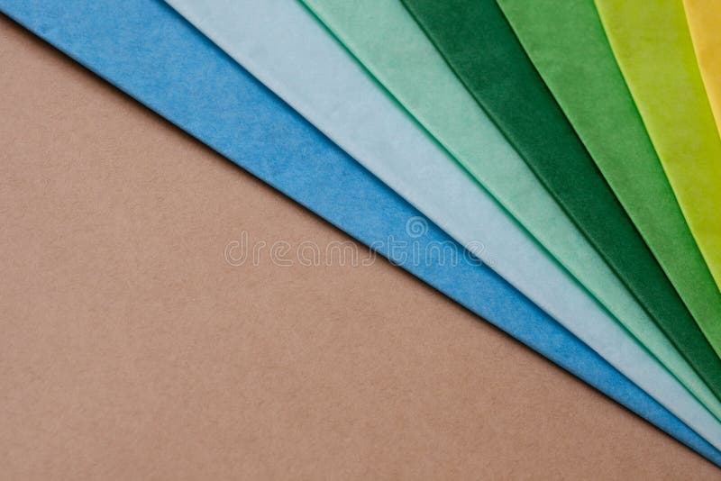 A Stack of Multi Colored Tissue Paper Spread Out in a Fan on a ...
