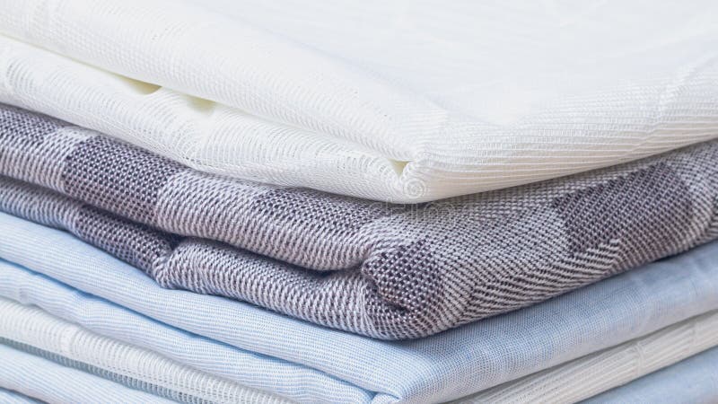 A Stack of New Fabric in White, Gray, Blue Colors is Neatly Folded ...