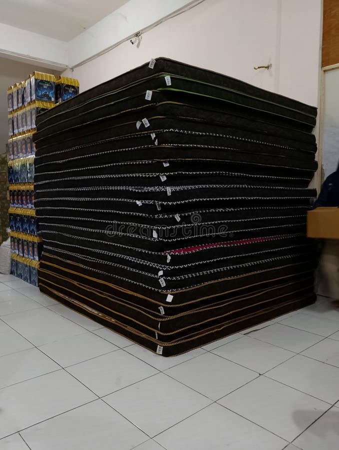 A Stack of New Mattresses Ready for Delivery in a Warehouse Stock Image ...