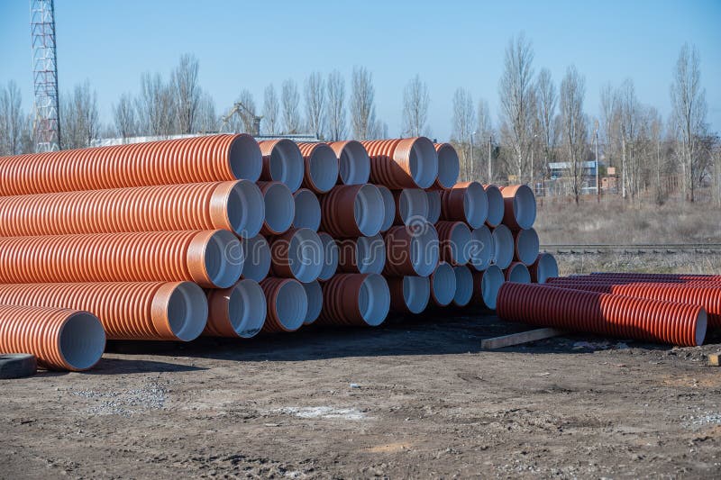 Stack of New Orange Polypropylene Pipes Outside. Plastic Pipes for ...