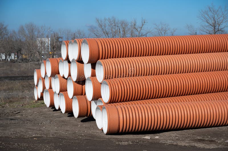 Stack of New Orange Polypropylene Pipes Outside. Plastic Pipes for ...