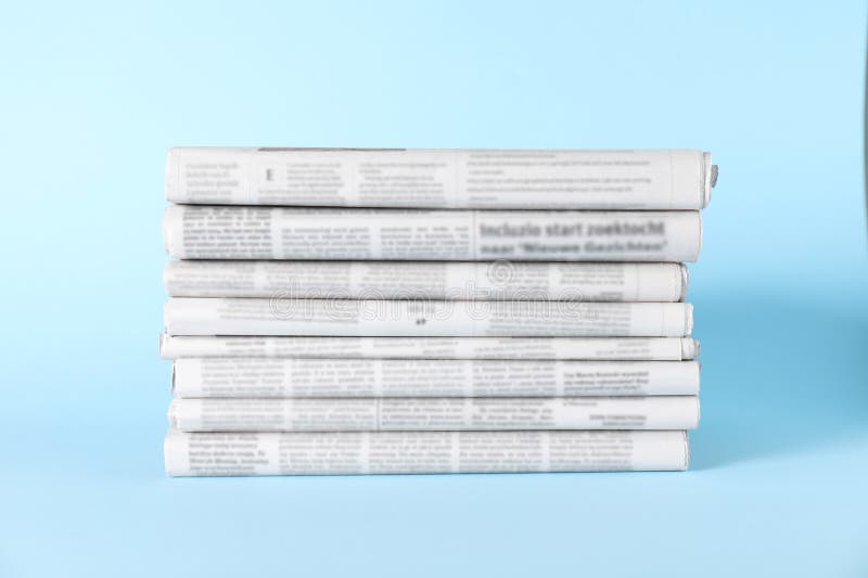 Stack of Newspapers in Different Languages on Light Blue Background ...