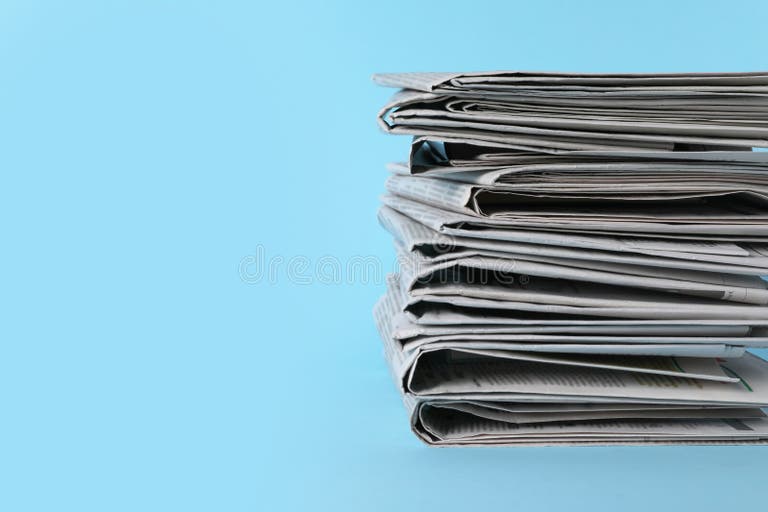 Stack of Newspapers in Different Languages on Light Blue Background ...