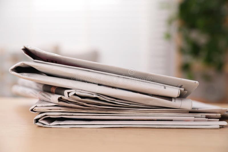 Stack of Newspapers in Different Languages on Table Indoors, Closeup ...