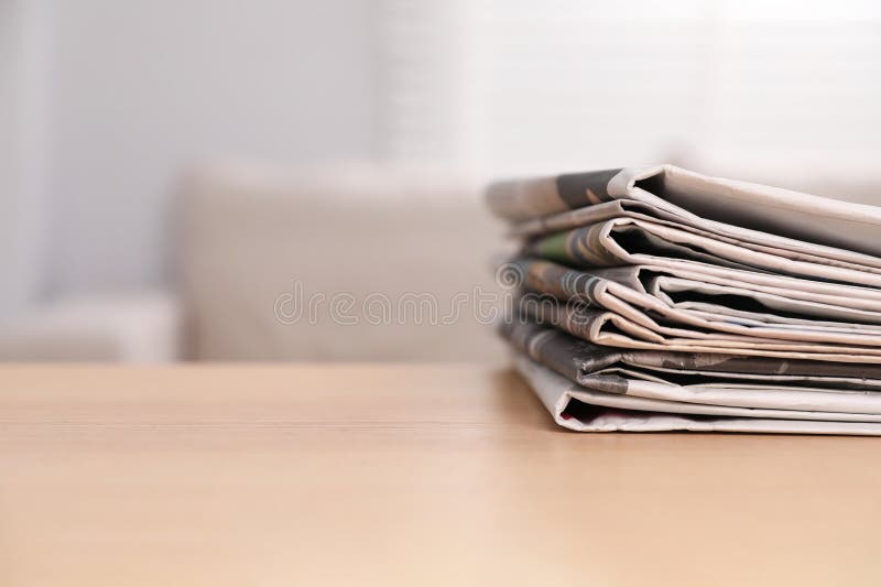 Stack of Newspapers in Different Languages on Table Indoors. Space for ...