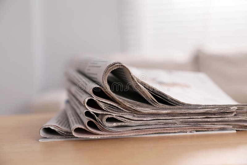 Stack of Newspapers in Different Languages on Table Indoors, Closeup ...