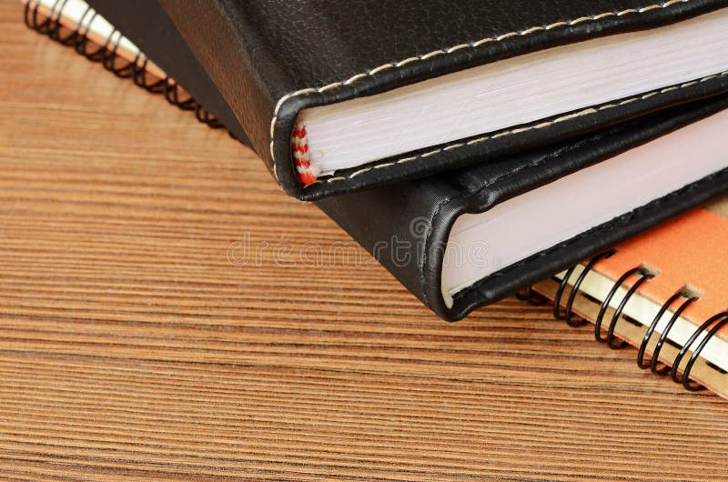 Stack of Notebooks on a Table Stock Image - Image of bookmarks, orange ...