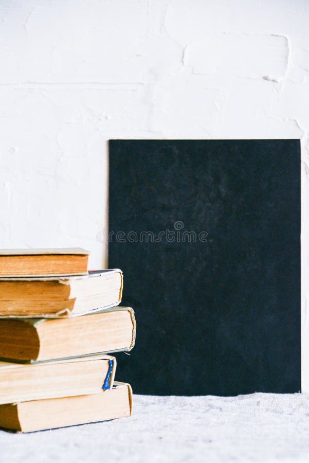 A Stack of Old Battered Books, and Graphite Board for Writing with ...