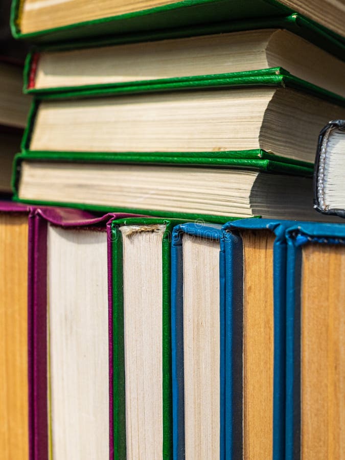 A Stack of Old Books in the Book Market. Stacked Books on a Shelf Stock ...