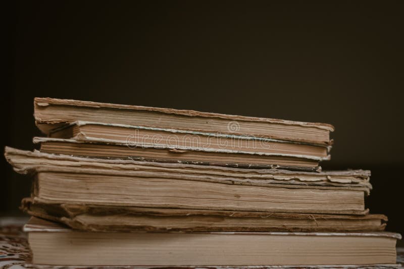 A Stack of Old Books with Frayed Spines and Yellowed Pages Stock Photo ...