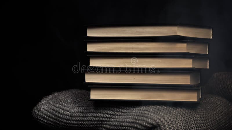Stack of Old Books among Magical Smoke or Fog on Black Background Stock ...