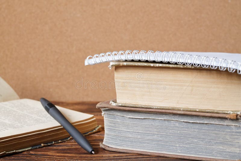 Stack of Old Books, Notebook, Opened Book with Pen on Wooden Tab Stock ...