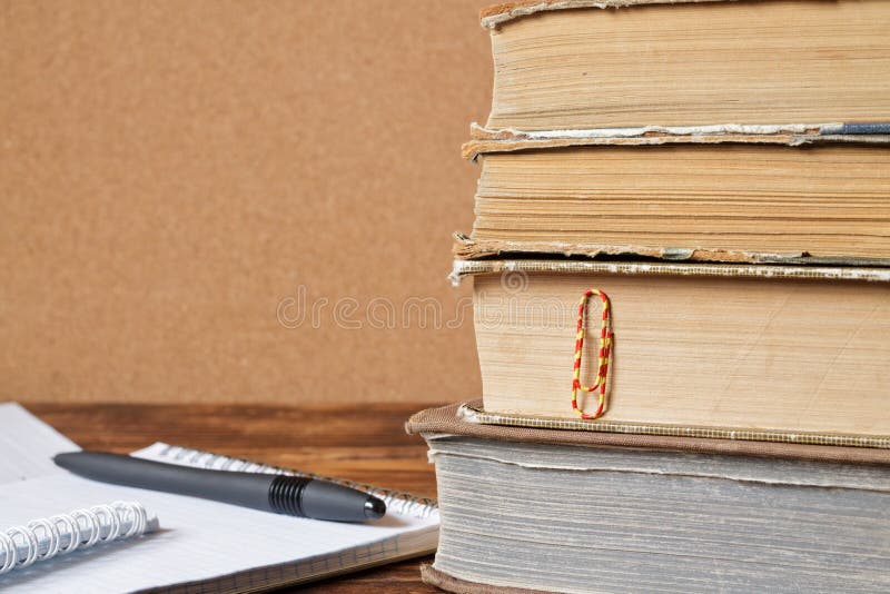 Stack of Old Books, Notebook with Pen on Wooden Table Stock Image ...
