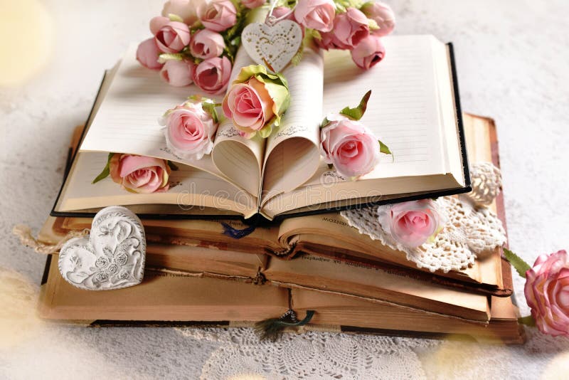 A Stack of Old Books with Pink Roses and Heart Decors Stock Photo ...