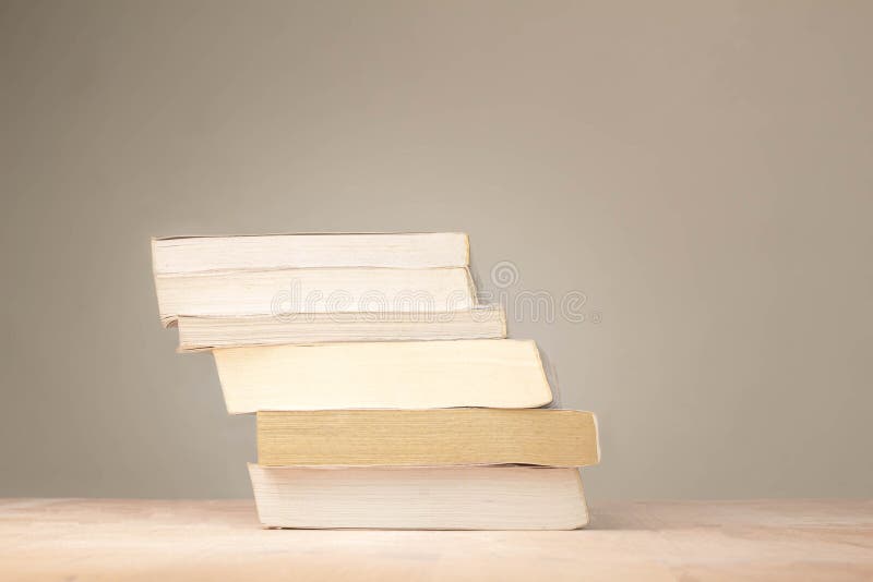 A Stack of Old Books Resting on a Dusty Desk in Room Stock Photo ...