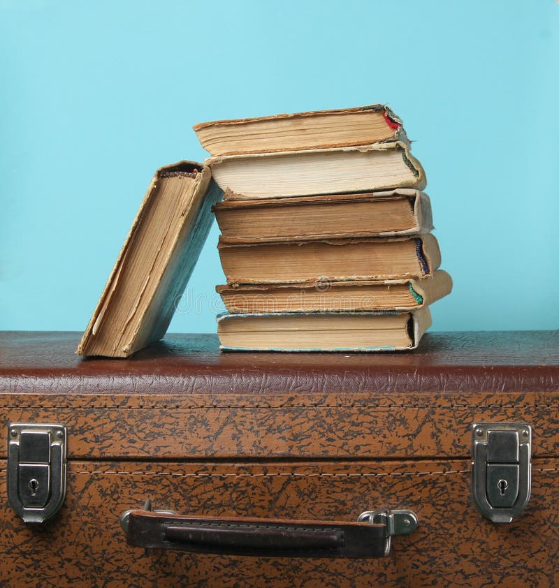 Stack of Old Books on Retro Suitcase on a Blue Background. Stock Image ...