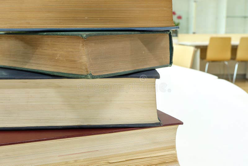 A Stack of Old Books with Old Paper Pages on Wooden Table and Beautiful ...