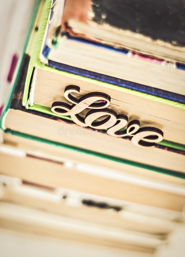 On a Stack of Old Books Wooden Word Love Stock Photo - Image of ...