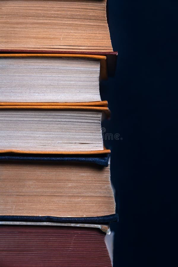 Stack of Old Dusty Hardback Books on a Dark Background. Stock Image ...