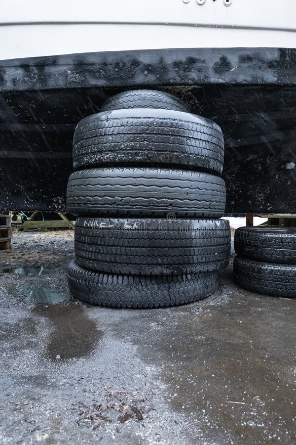 Stack of Old Tires Supporting a Boat on Land.. Stock Photo - Image of ...