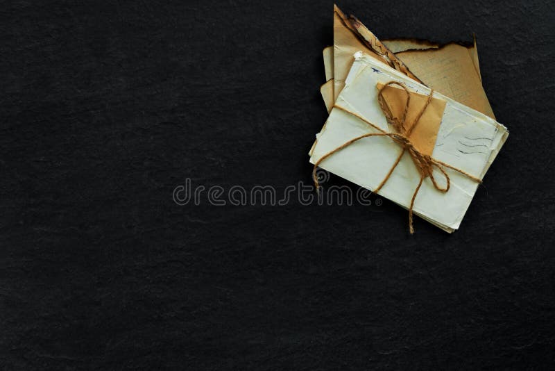 Stack of Old Torn Vintage Letters on Yellowed Paper Against Black ...