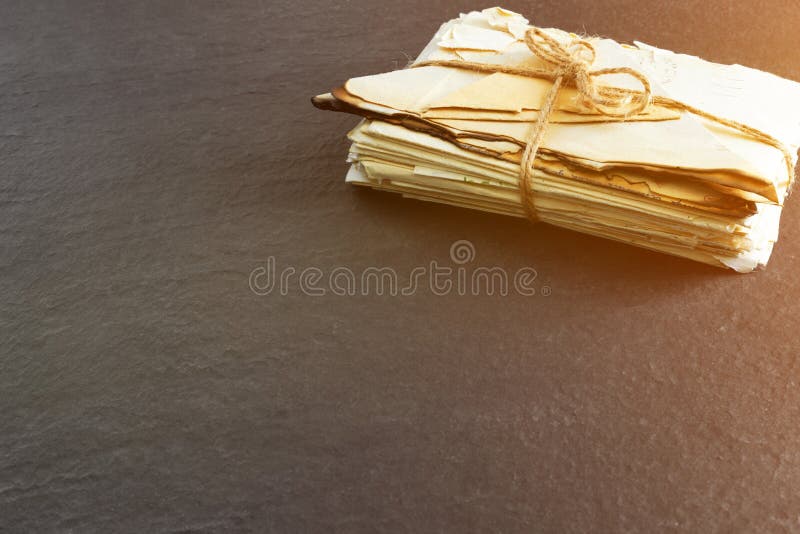 Stack of Old Torn Vintage Letters on Yellowed Paper Against Black ...