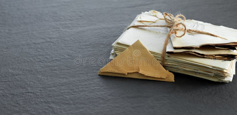 Stack of Old Torn Vintage Letters on Yellowed Paper Against Black ...