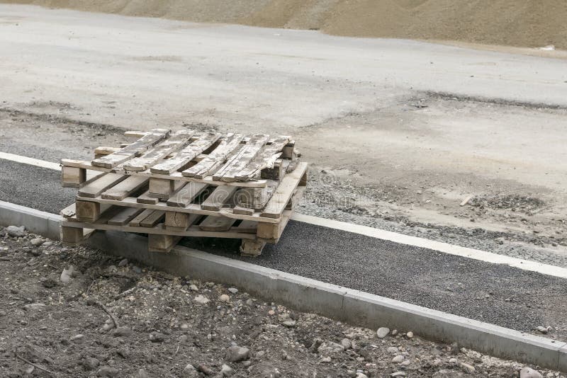 A Stack of Old Wooden Pallets on the Asphalt Path. Stock Image - Image ...