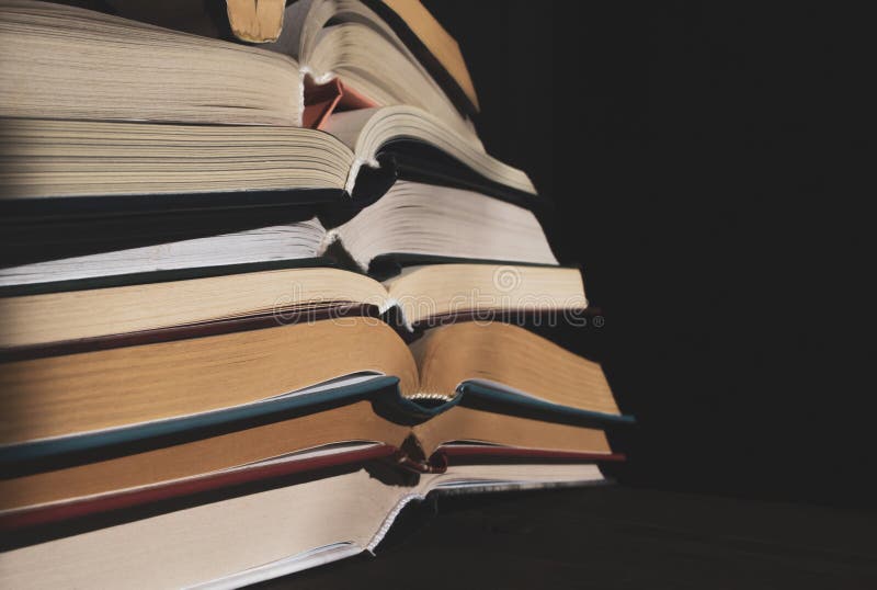 A Stack of Open Books in the Dark. Lots of Books on a Dark Background ...