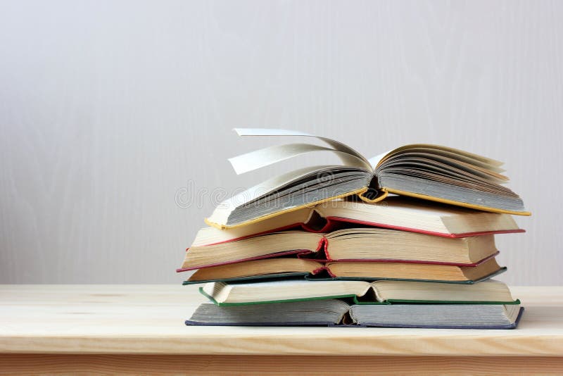 Stack of Open Paper Books in Hard Color Covers on the Table Stock Photo ...