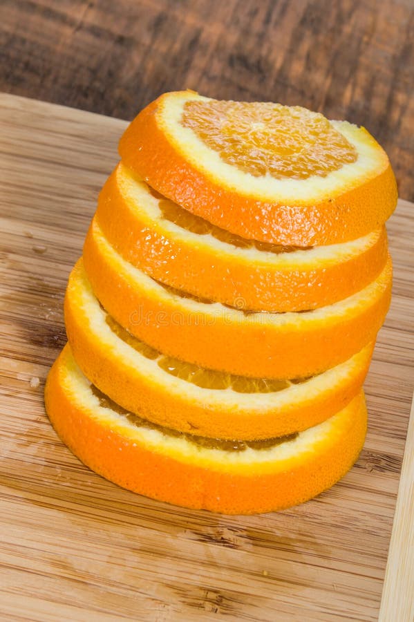 Stack of Orange Slices on Board Stock Photo - Image of ripe, organic ...