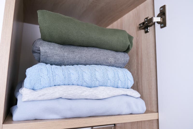 A Stack of Organized Clothes on a Shelf in a Wardrobe Stock Image ...