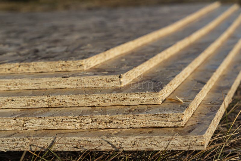 A Stack of OSB Sheets Lying on the Grass. Stock Photo - Image of ...