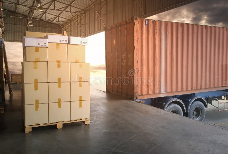 Stack of Package Boxes with Cargo Container. Trailer Parked Loading at ...