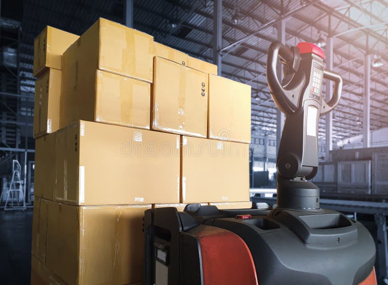 Stack of Package Boxes with Forklift Pallet Jack at Storage Warehouse ...