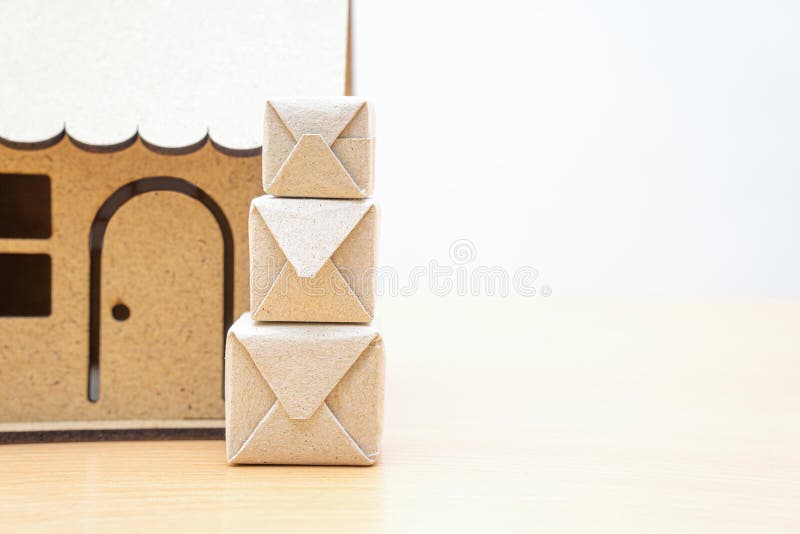Stack of Packages by a House Model Isolated on White Stock Photo ...