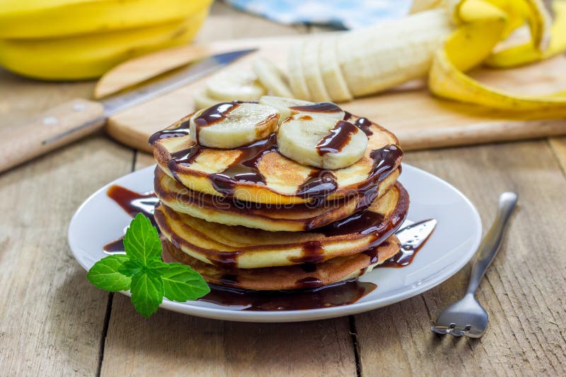 Stack of Pancakes with Banana and Chocolate Syrup Stock Photo - Image ...