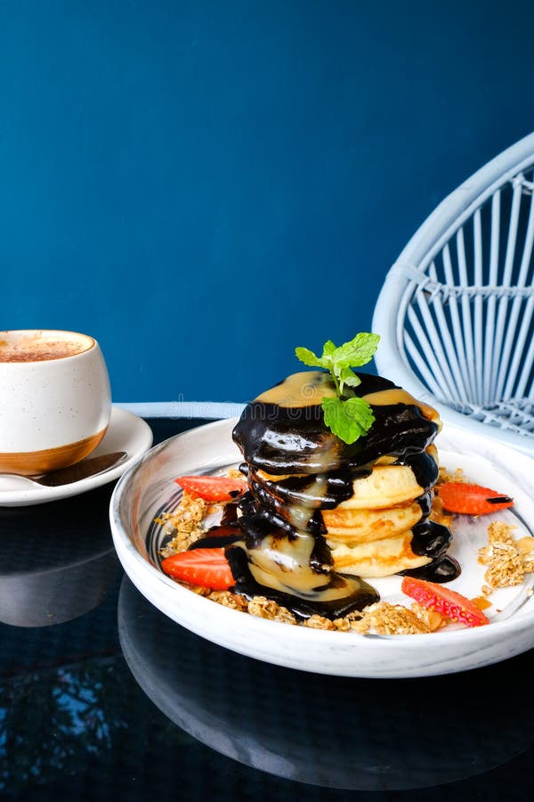 Stack of Pancakes with Chocolate Syrup, Caramel and Strawberries and ...