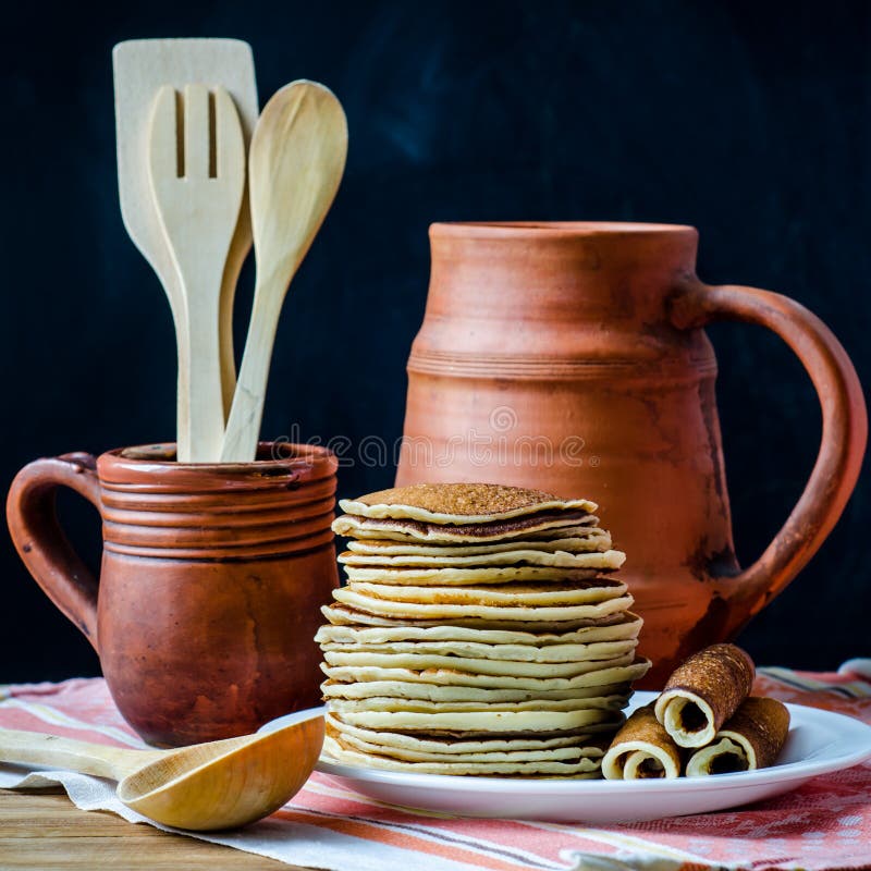 Stack of Pancakes, Clay Jug and Mug with Wooden Cutlery Stock Photo ...