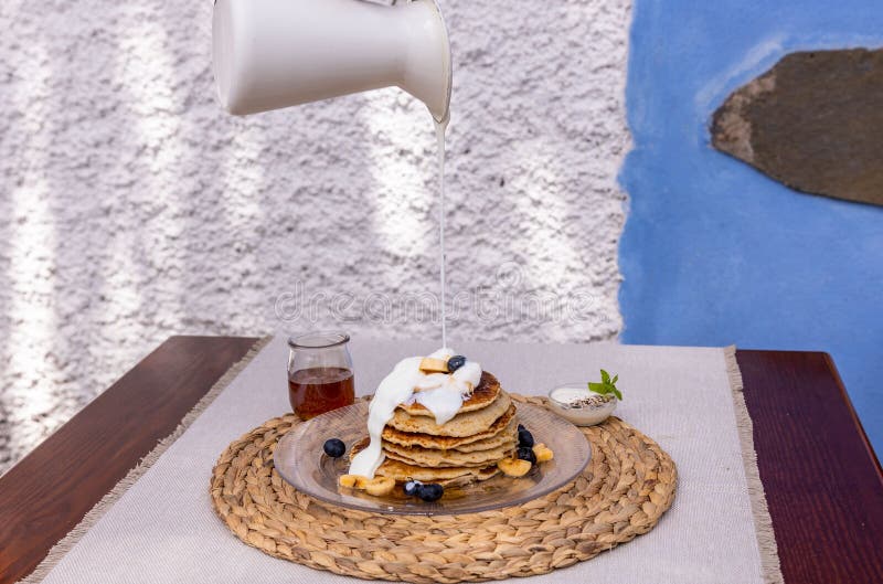 Stack of Pancakes on a Glass Plate with Cream Falling on it Stock Image ...