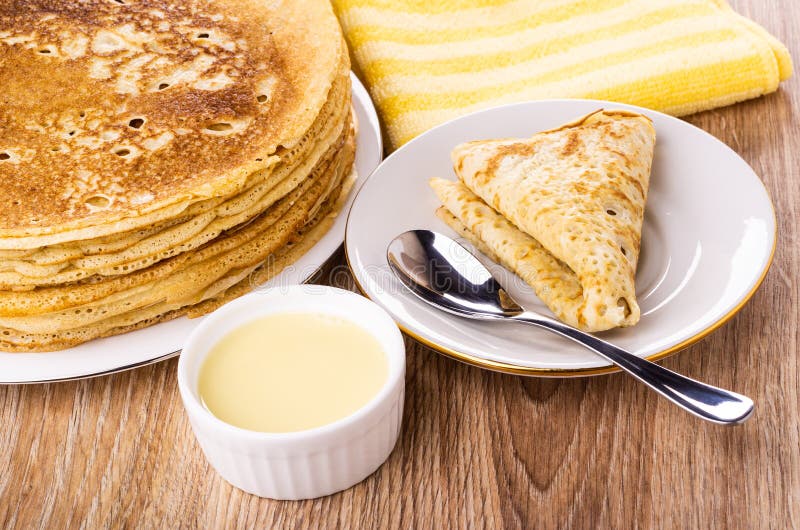 Pancakes in Plate, Spoon with Condensed Milk on Pancake in Saucer ...
