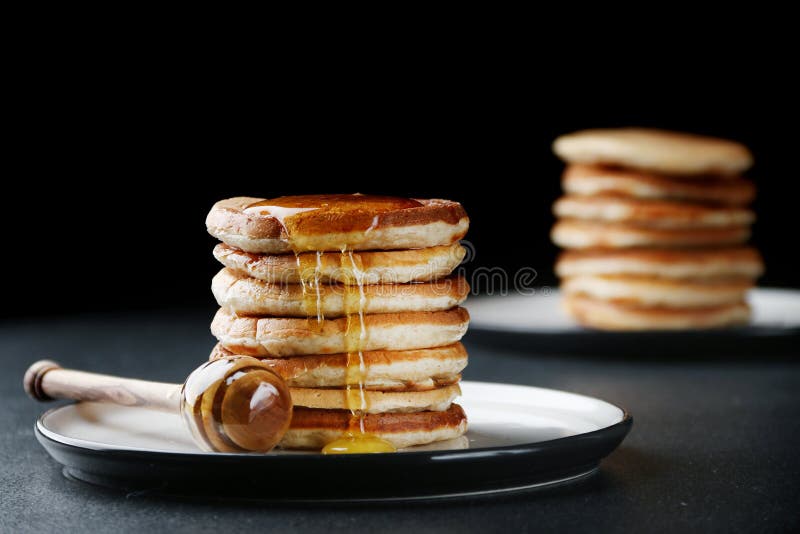 Stack of Pancakes with Pouring Honey on Dark Background. Decoration ...