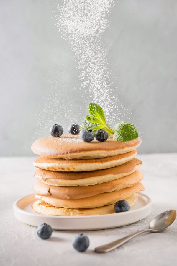 Sweet Homemade Stack of Pancakes with Powered Sugar on Black. Close Up ...